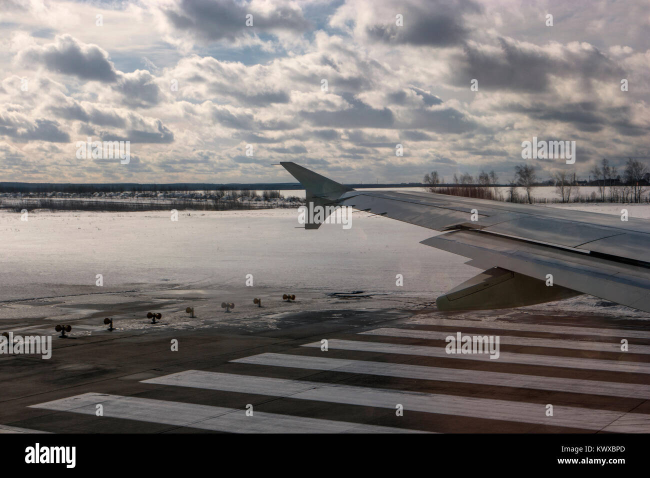 Aircraft on landing site in starting position. View from window at wing ...