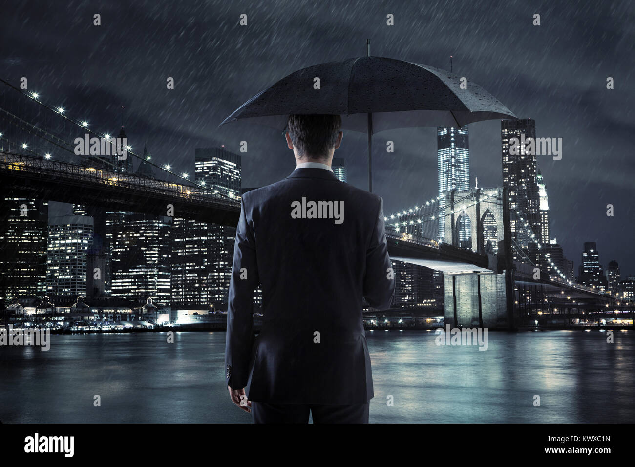 Young manager with an umbrella over the night city background Stock ...