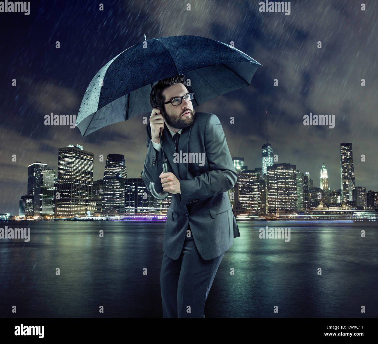 Afraid businessman in the heavy rain Stock Photo - Alamy