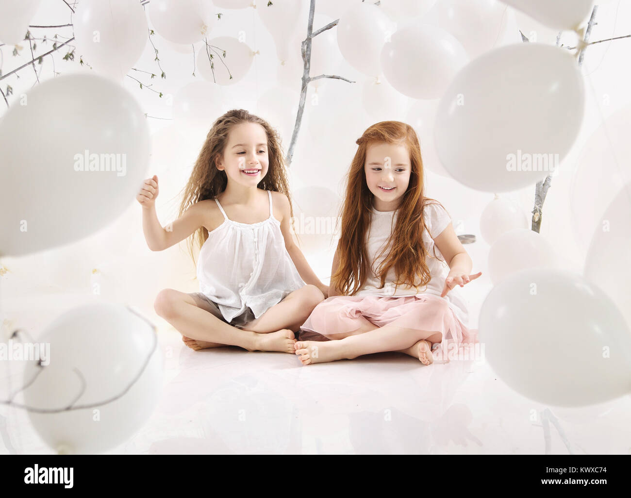 Two cheerfull girls playing together Stock Photo - Alamy