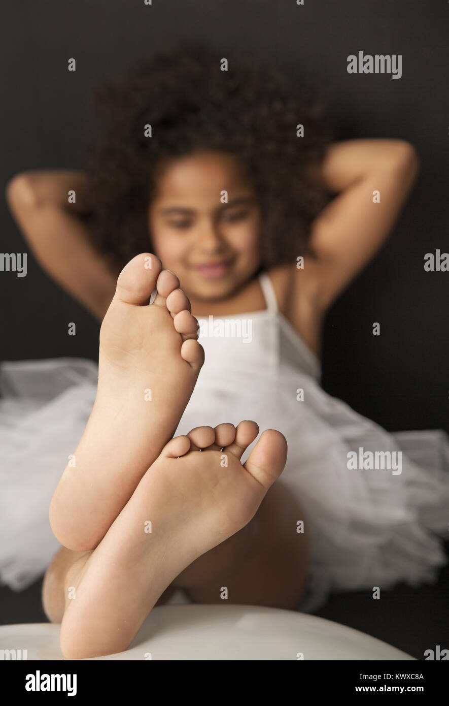 Little tired ballet dancer relaxing on the chair Stock Photo - Alamy