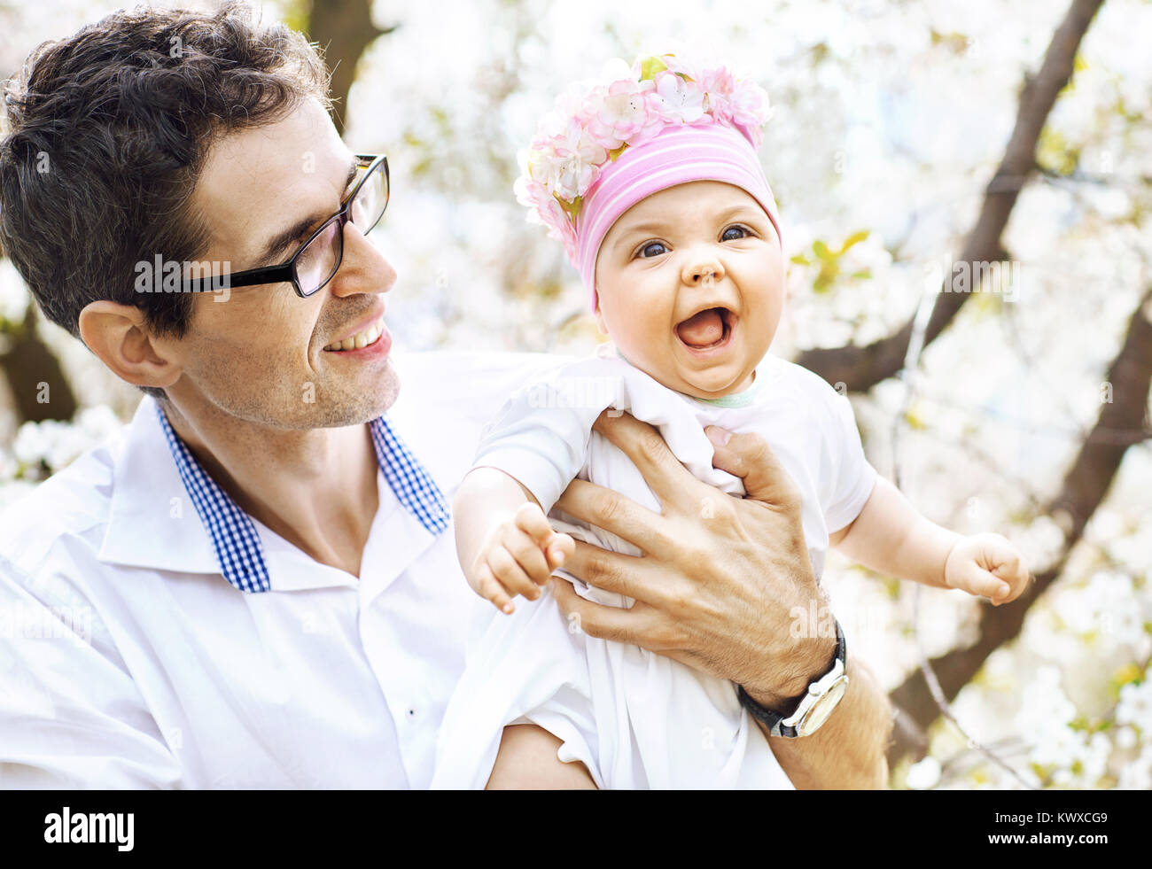 Cheerful father holding his beloved baby Stock Photo - Alamy