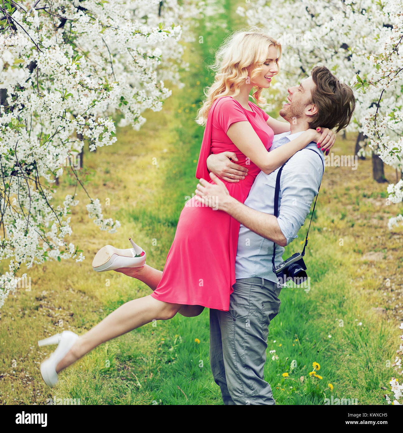 Handsome man holding his adorable girlfriend Stock Photo - Alamy