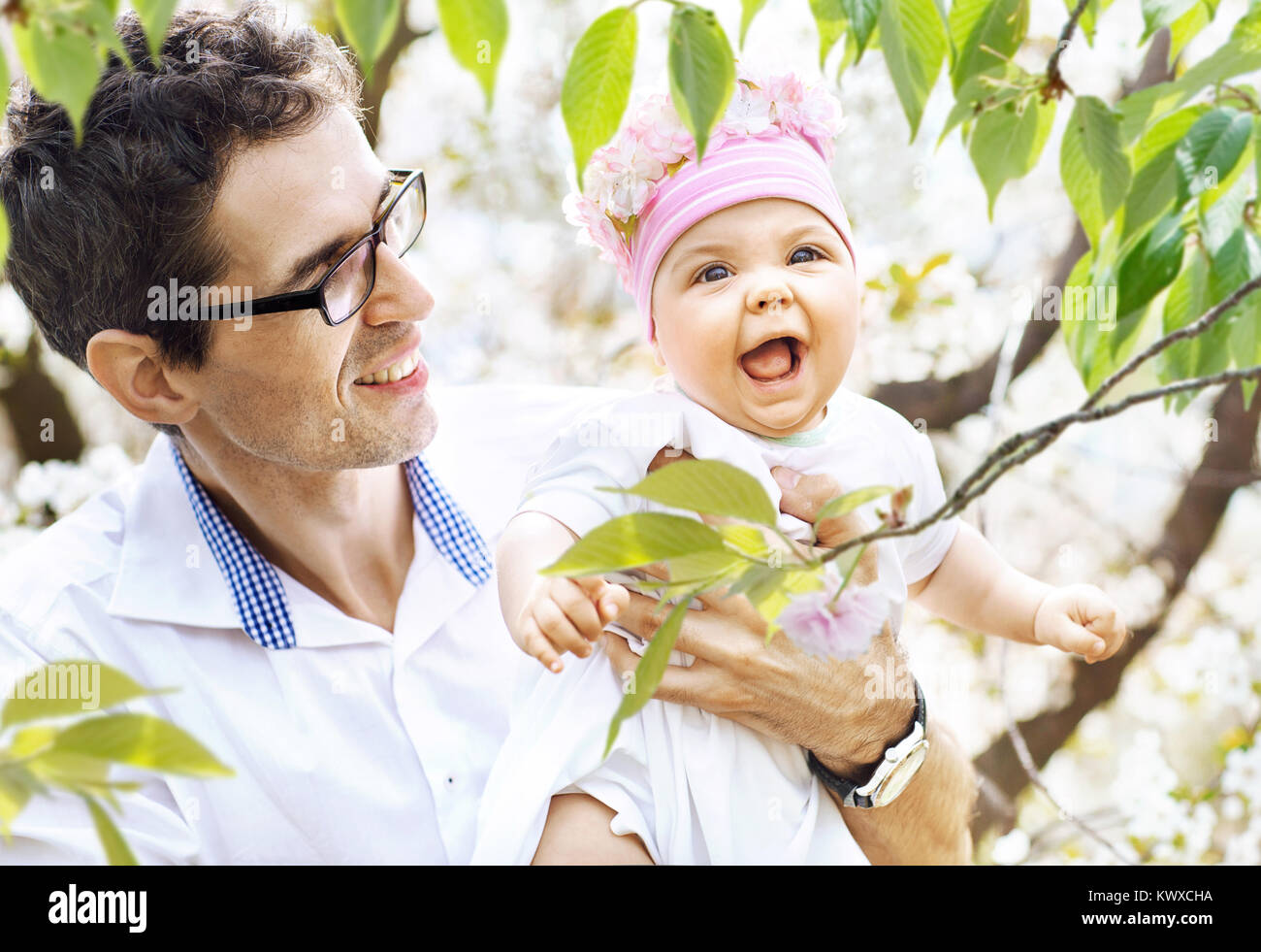 Handsome father looking at his lauhging child Stock Photo - Alamy