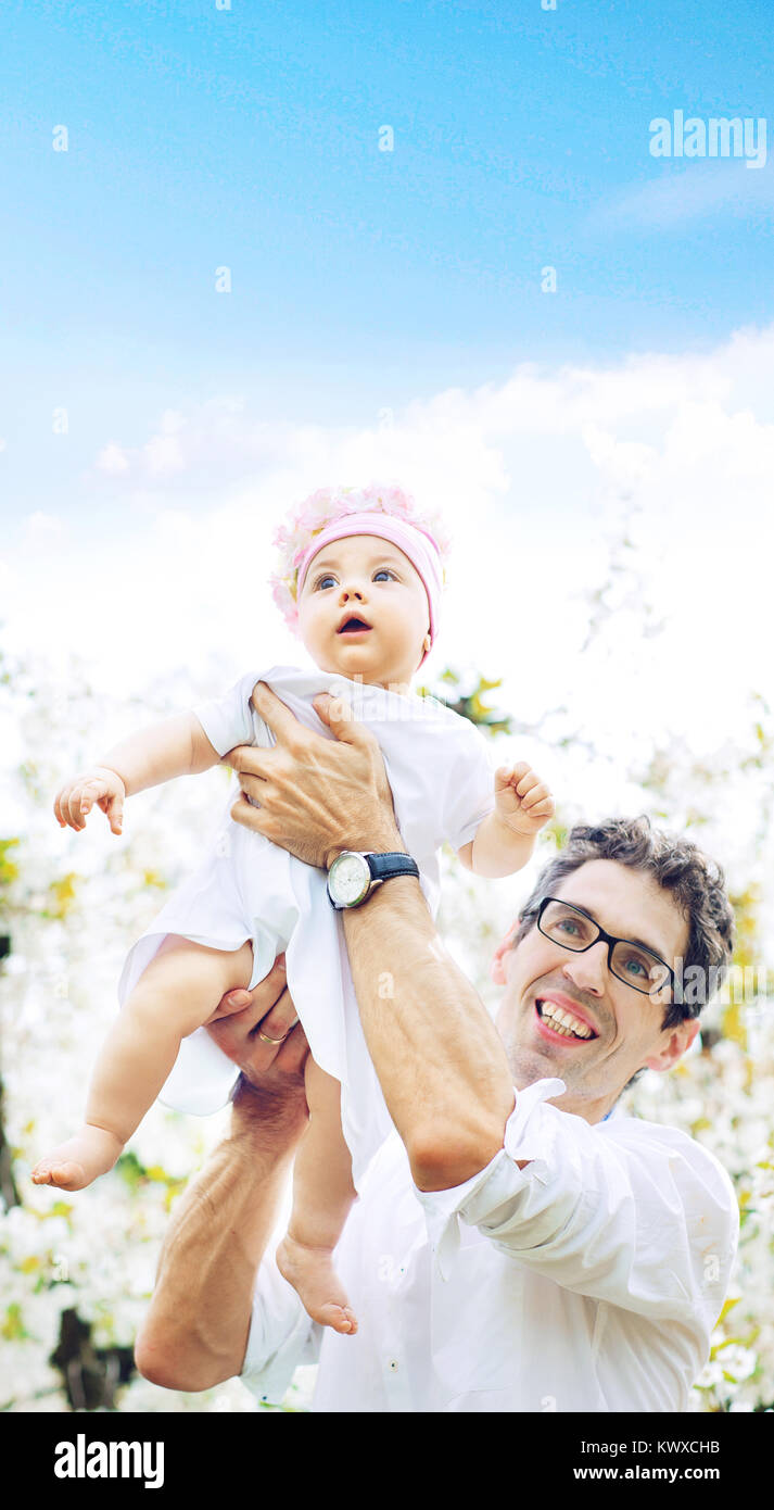 Cheerful father holding his beloved baby Stock Photo - Alamy