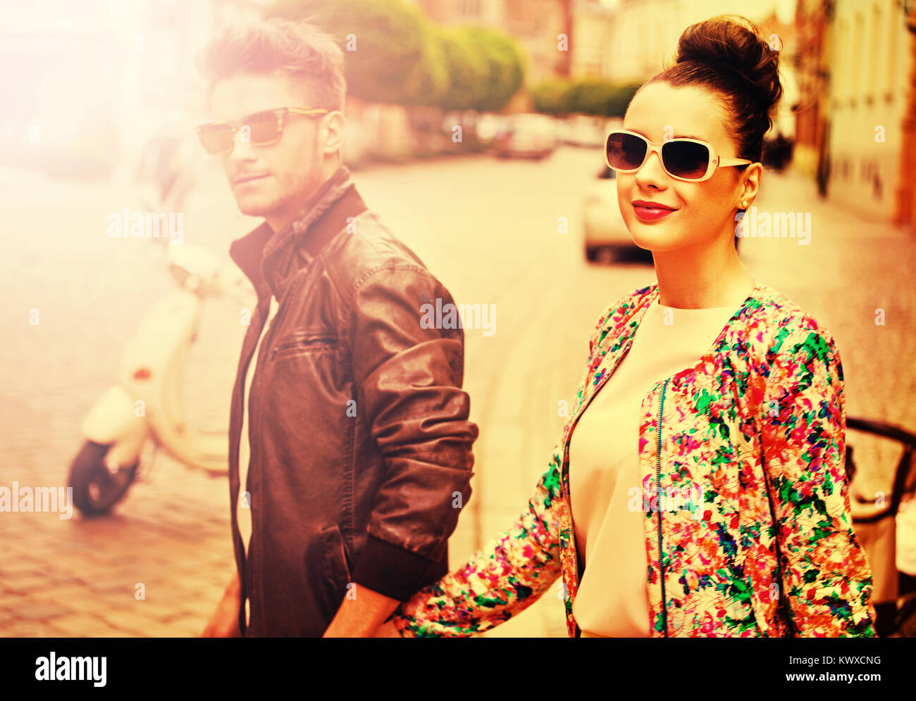 Attractive young couple walking in the downtown Stock Photo - Alamy