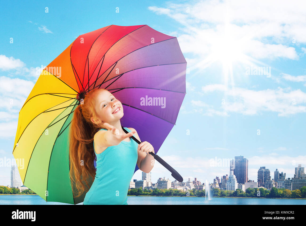 Pretty little girl with a colorful umbrella Stock Photo - Alamy