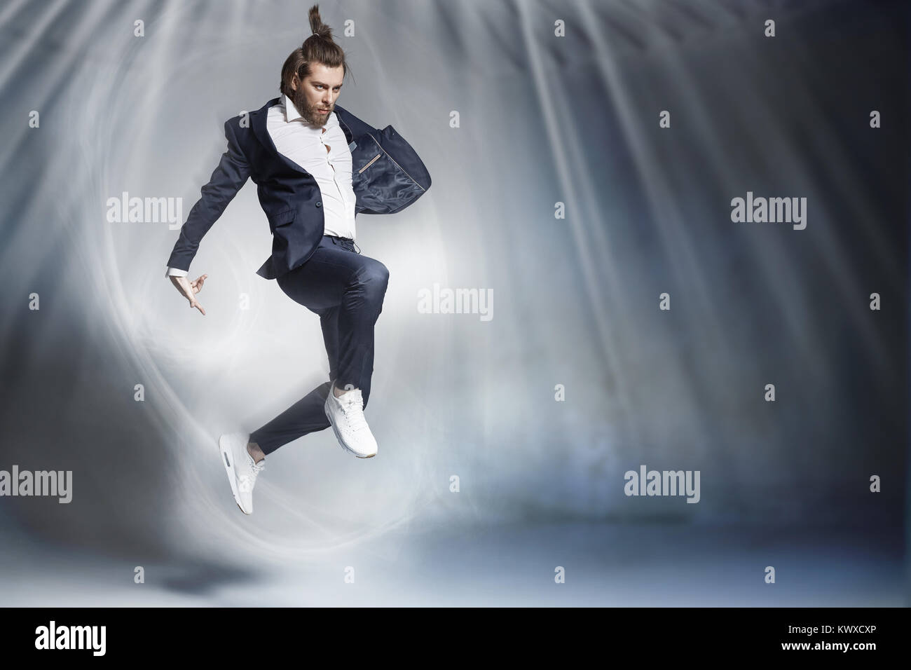 Handsome jumping businessman wearing stylish stuff Stock Photo - Alamy