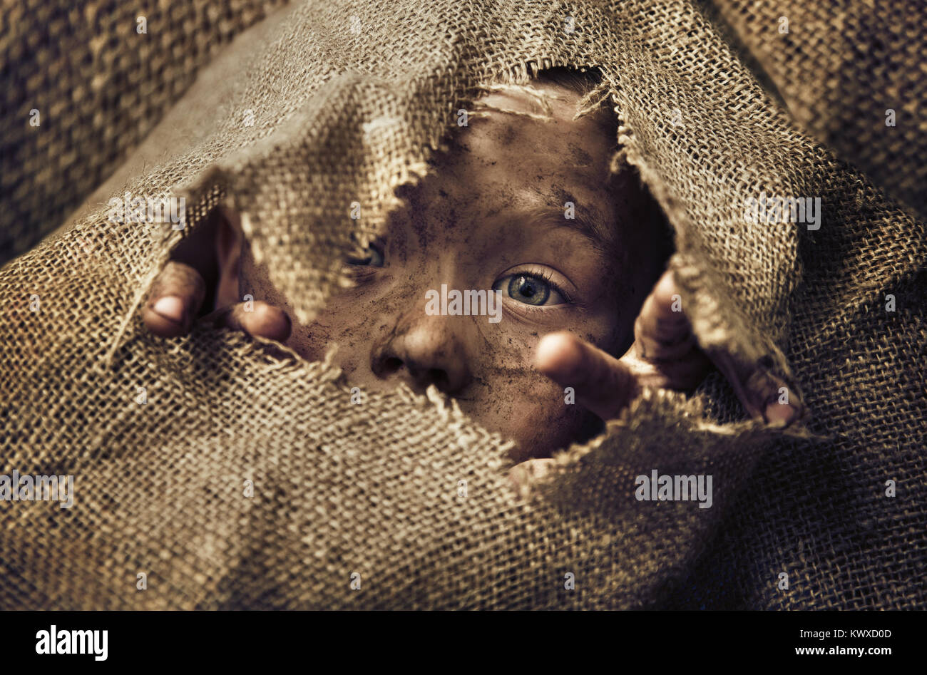Little homeless child wearing a bag Stock Photo - Alamy