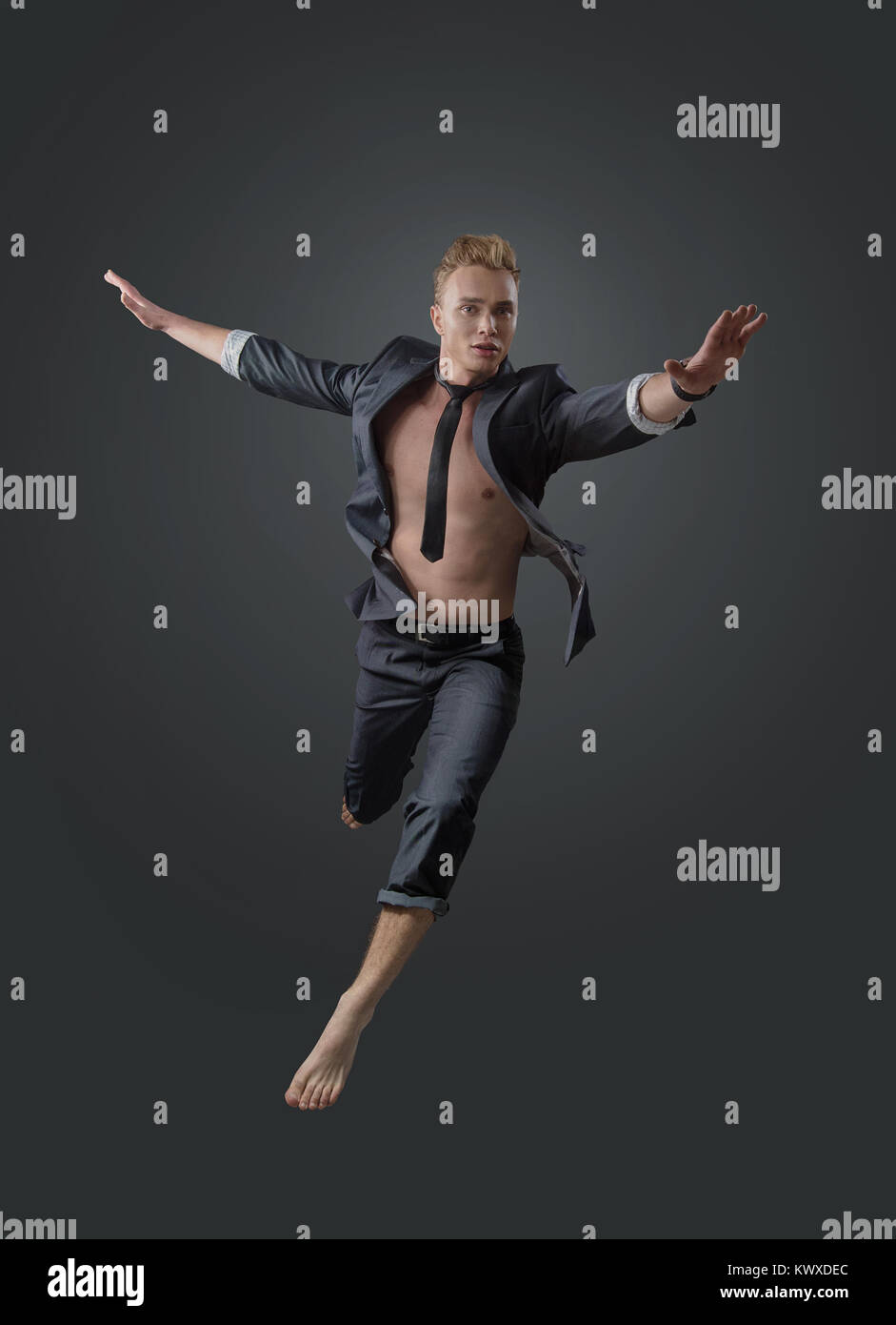 Portrait of a successful young manager in a jump pose Stock Photo - Alamy