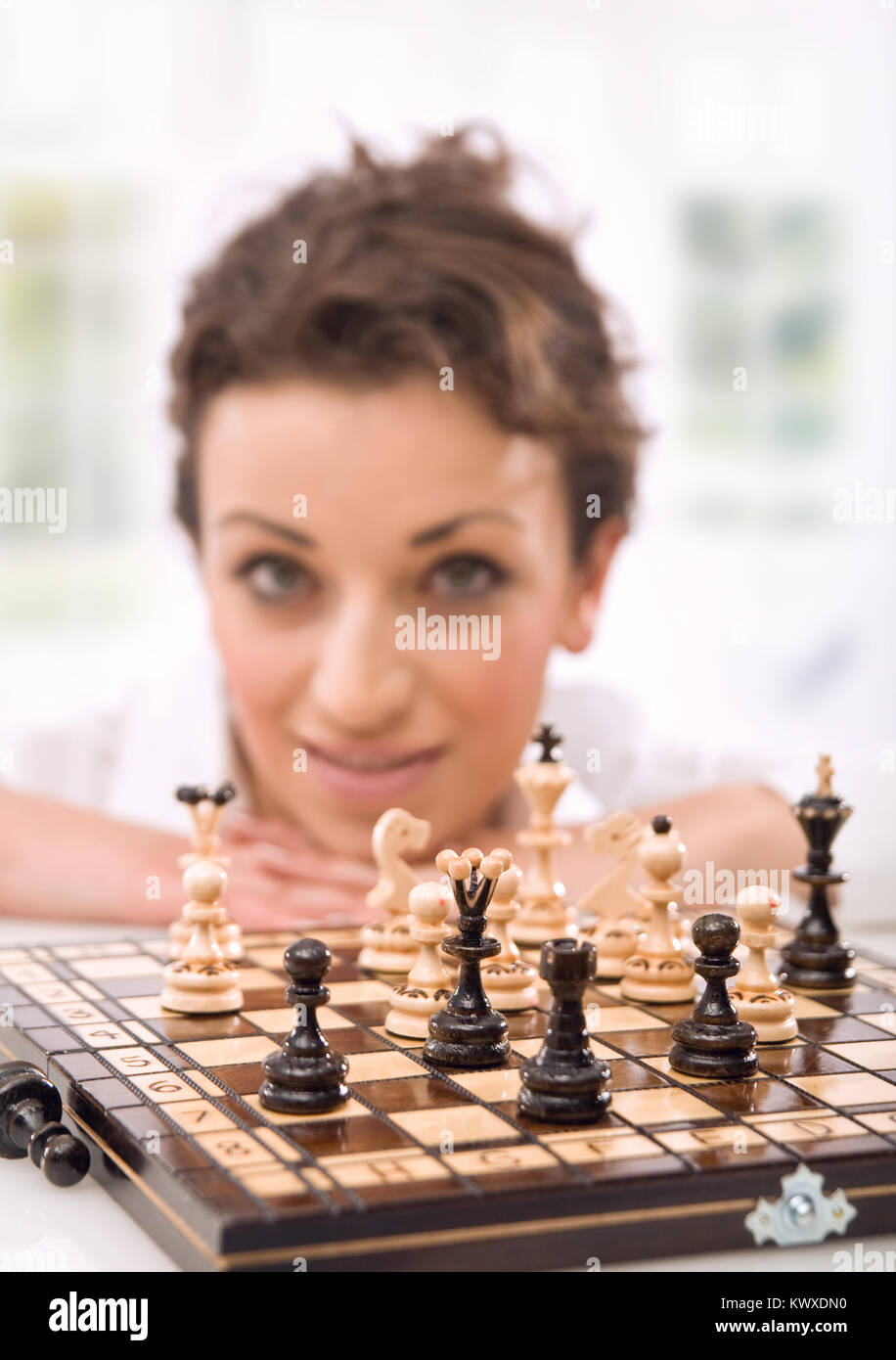 Portrait of a young woman with a chess set Stock Photo - Alamy