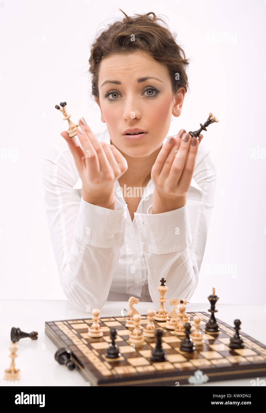 Pretty, young woman playing chess Stock Photo - Alamy