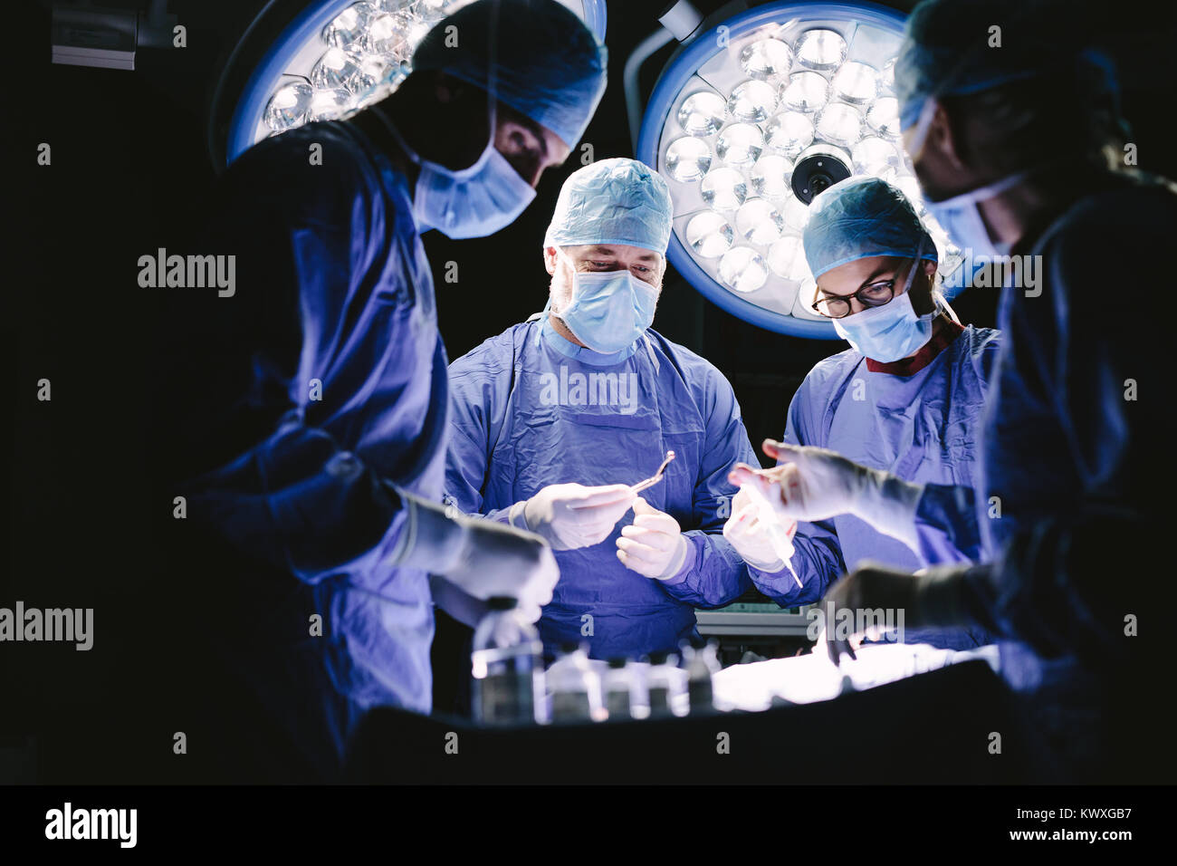 Group of medical professional performing surgery in operation theater ...