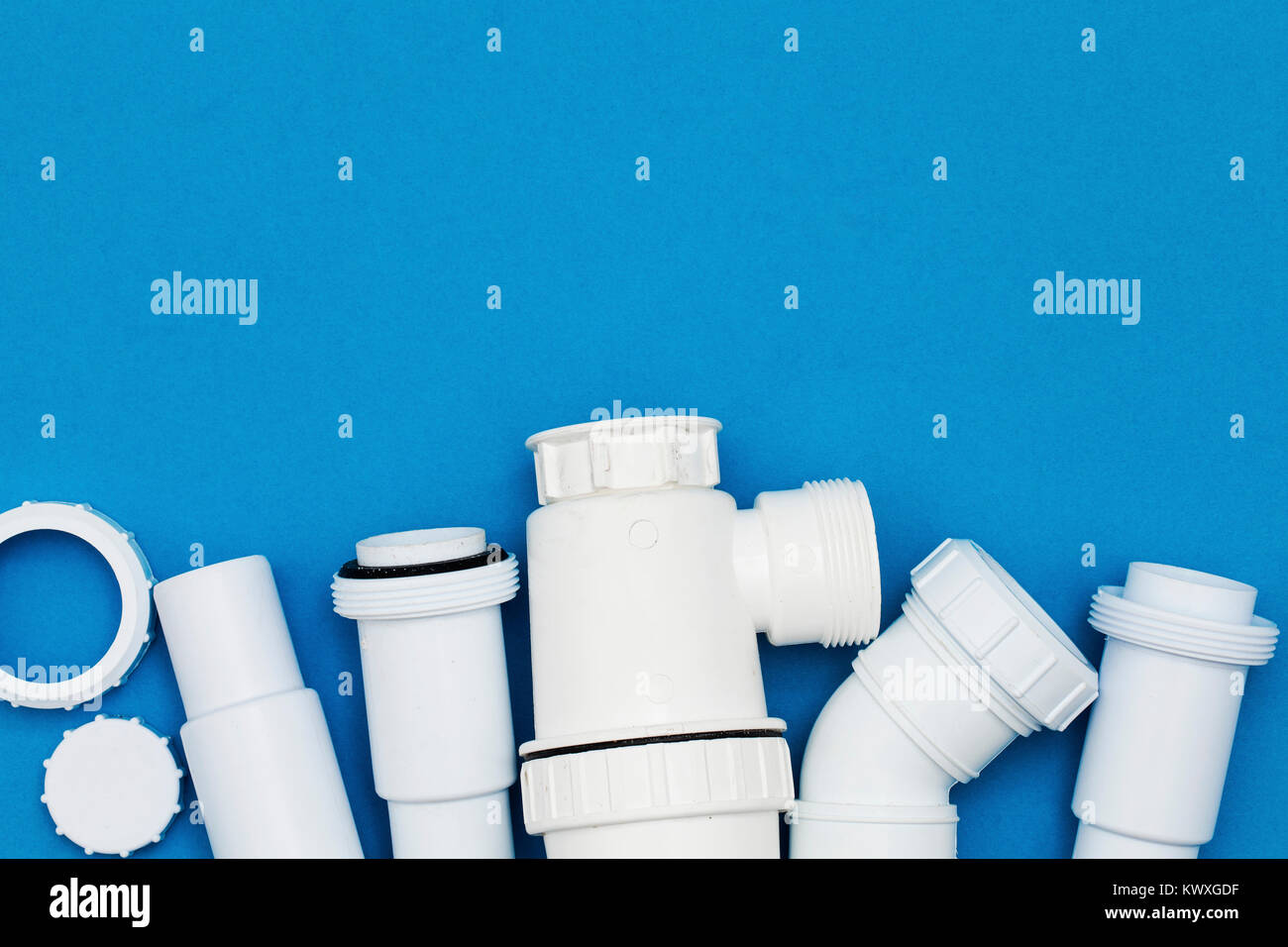 Plumbing waste pipes on a blue background Stock Photo - Alamy