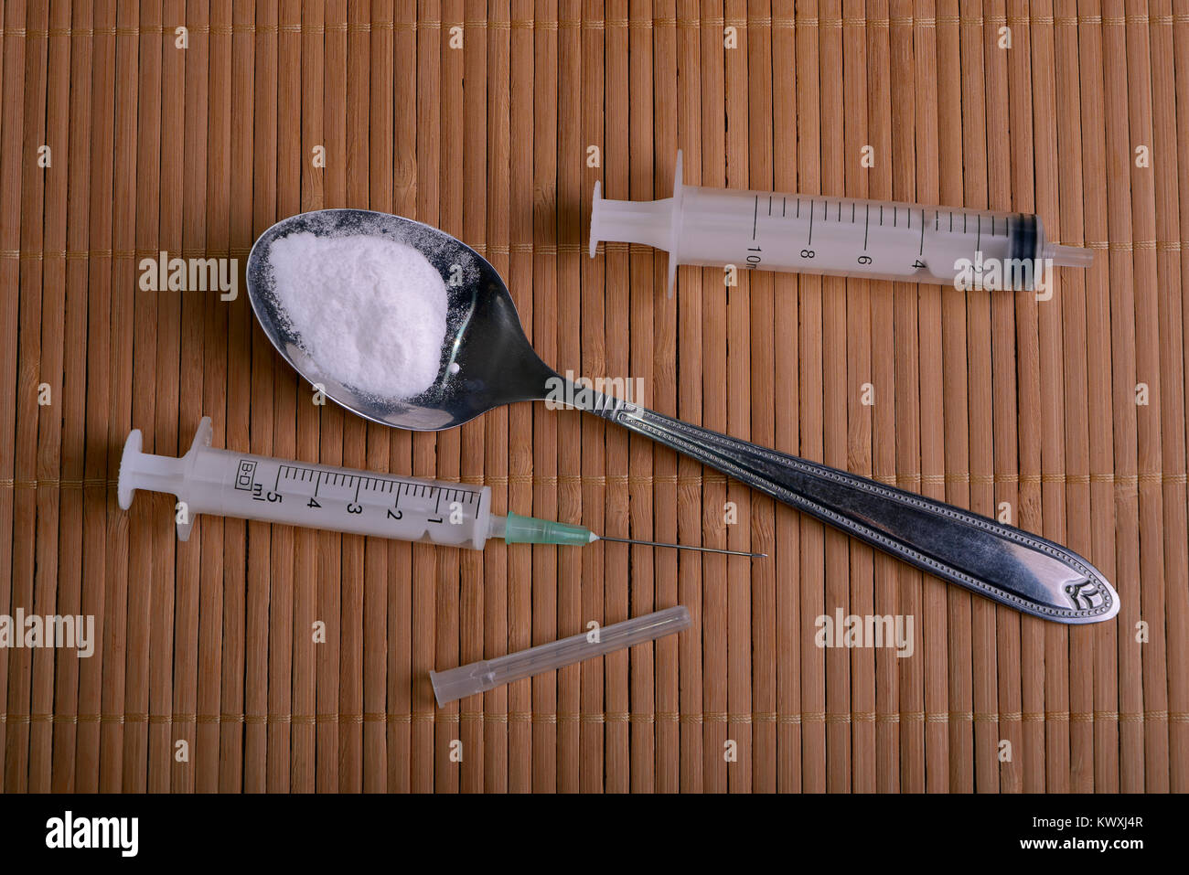 Disposable syringes and a white powder in the spoon, high view Stock ...