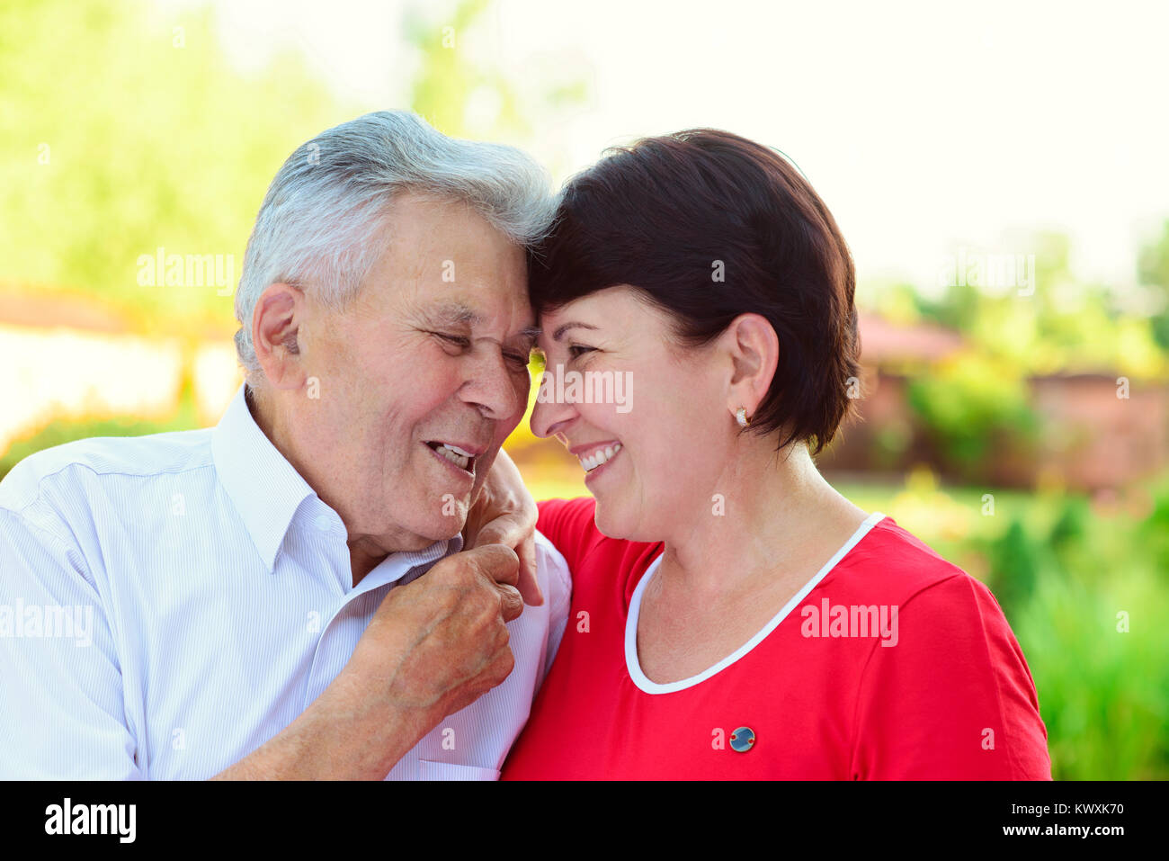 Portrait of happy old father and his 50 years daughter at homegarden ...