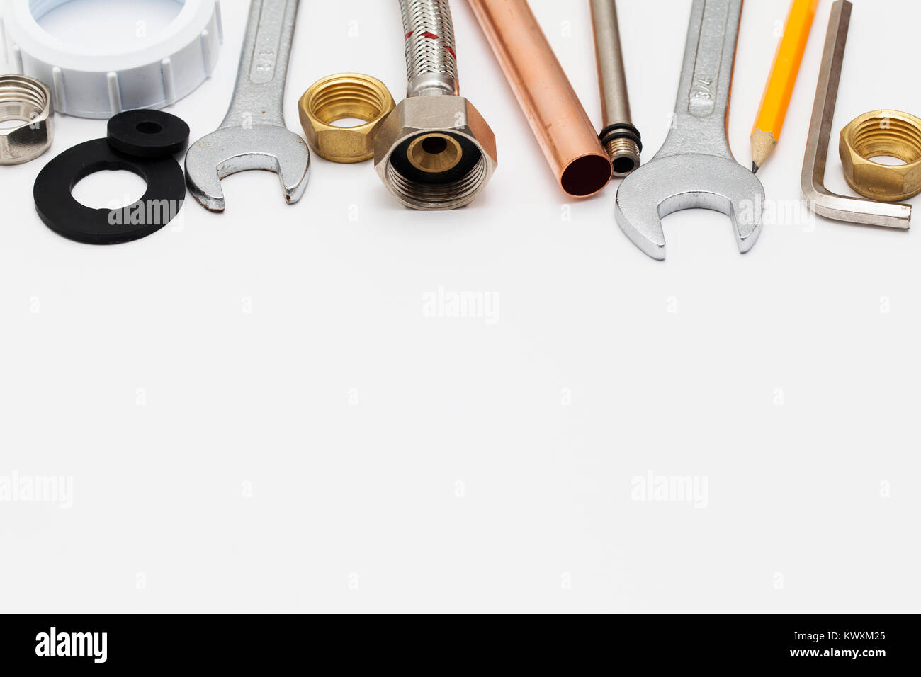 Plumbing essential tools on a plain background Stock Photo - Alamy