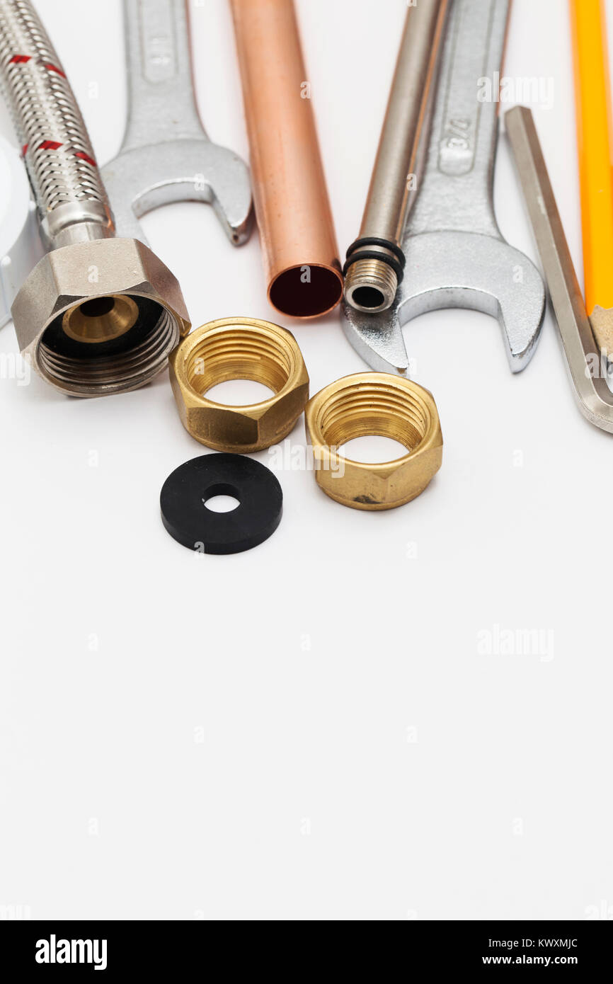 Plumbing essential tools on a plain background Stock Photo - Alamy