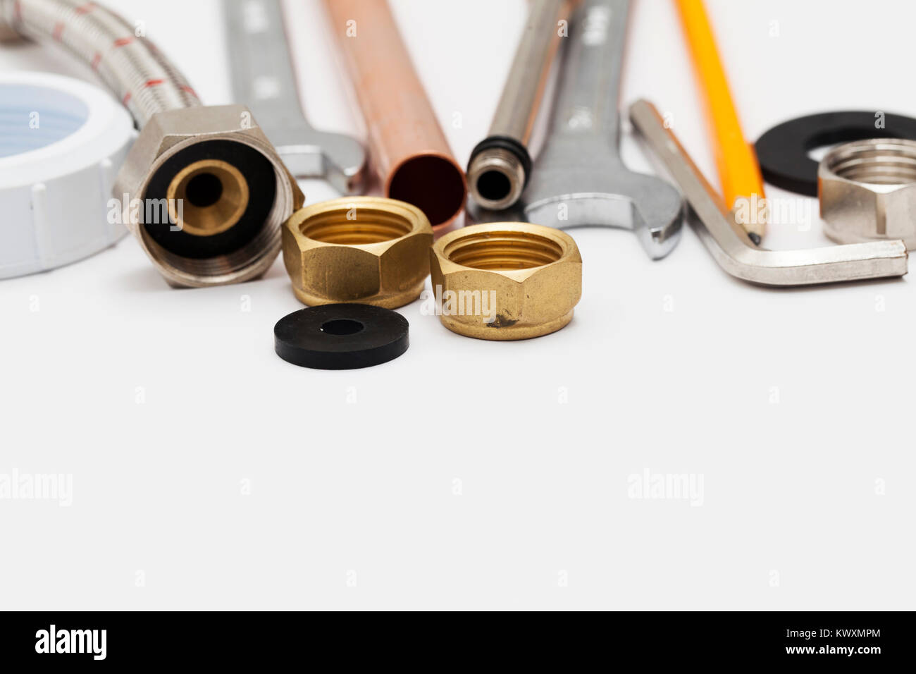 Plumbing essential tools on a plain background Stock Photo - Alamy