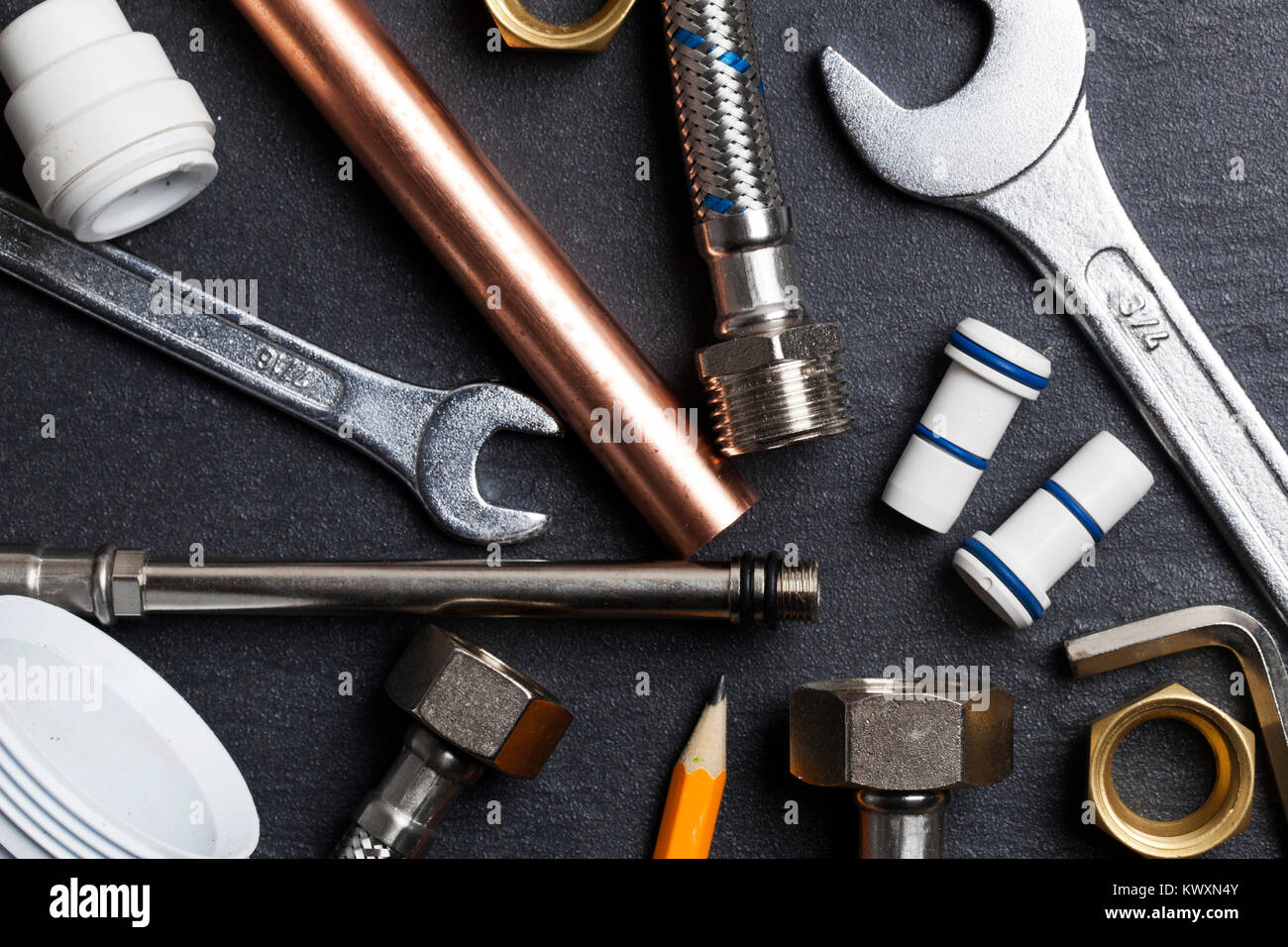 Plumbing concept. tools and pipes on a dark slate bakground Stock Photo ...