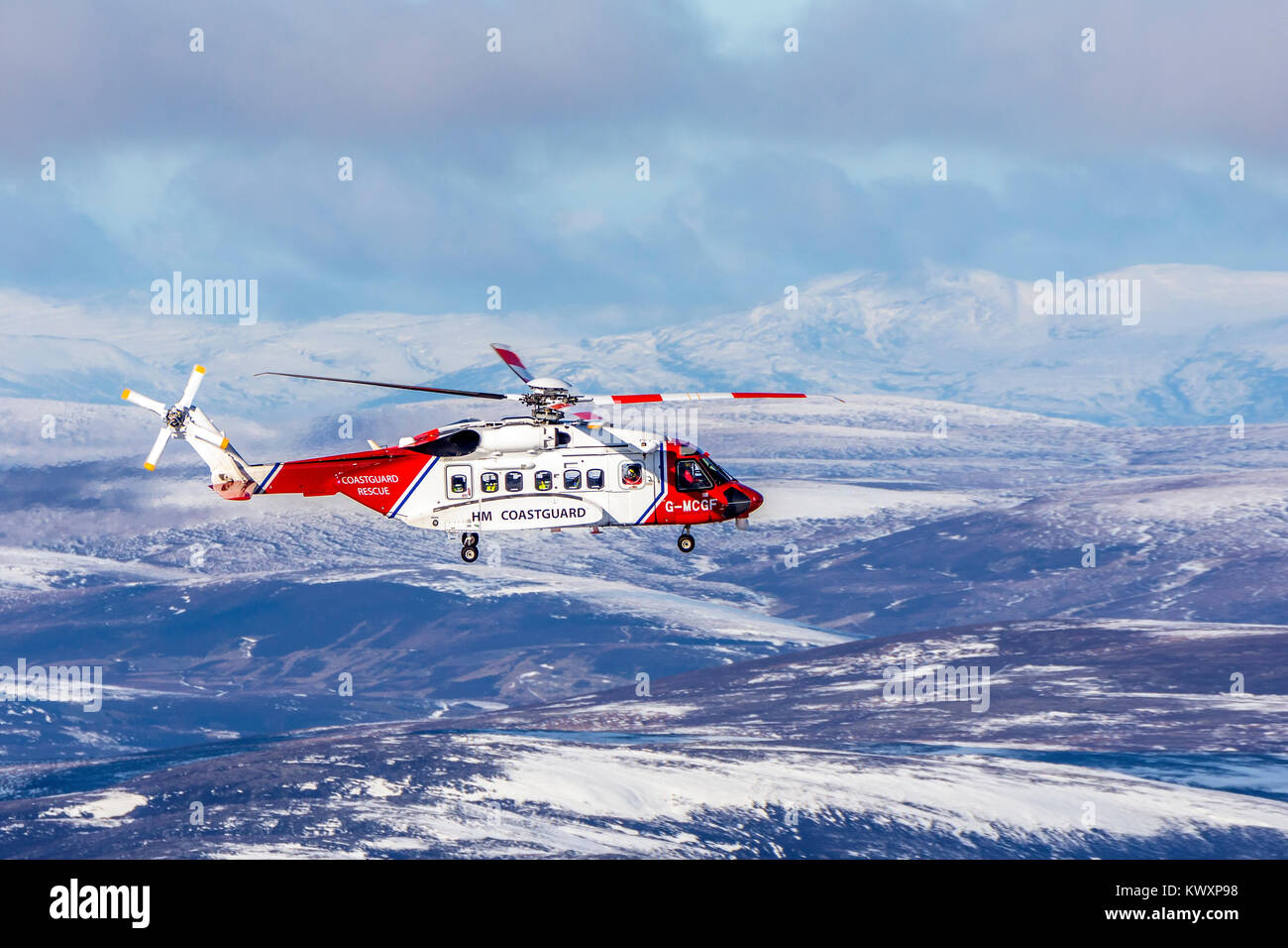 Coastguard helicopter flies over the cairngorms Stock Photo - Alamy