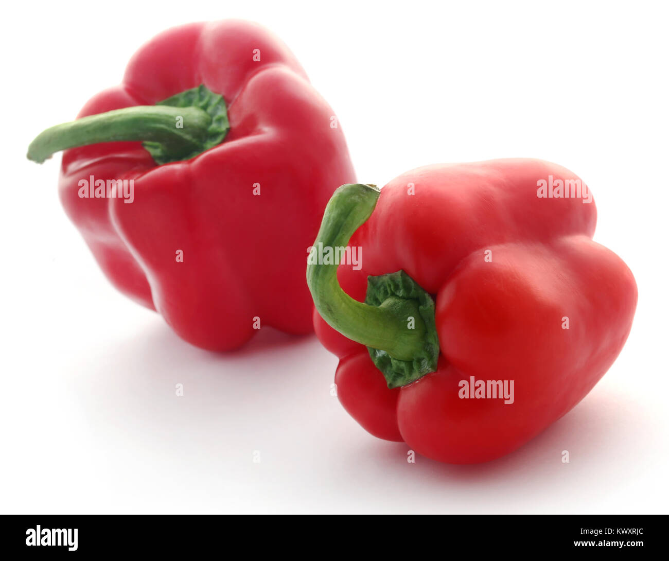 Two red capsicum over white background Stock Photo - Alamy