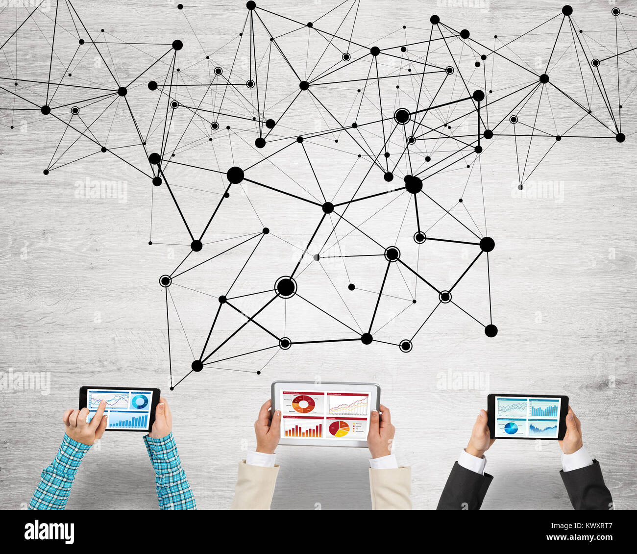 Group of three people with devices in hands working together as symbol ...