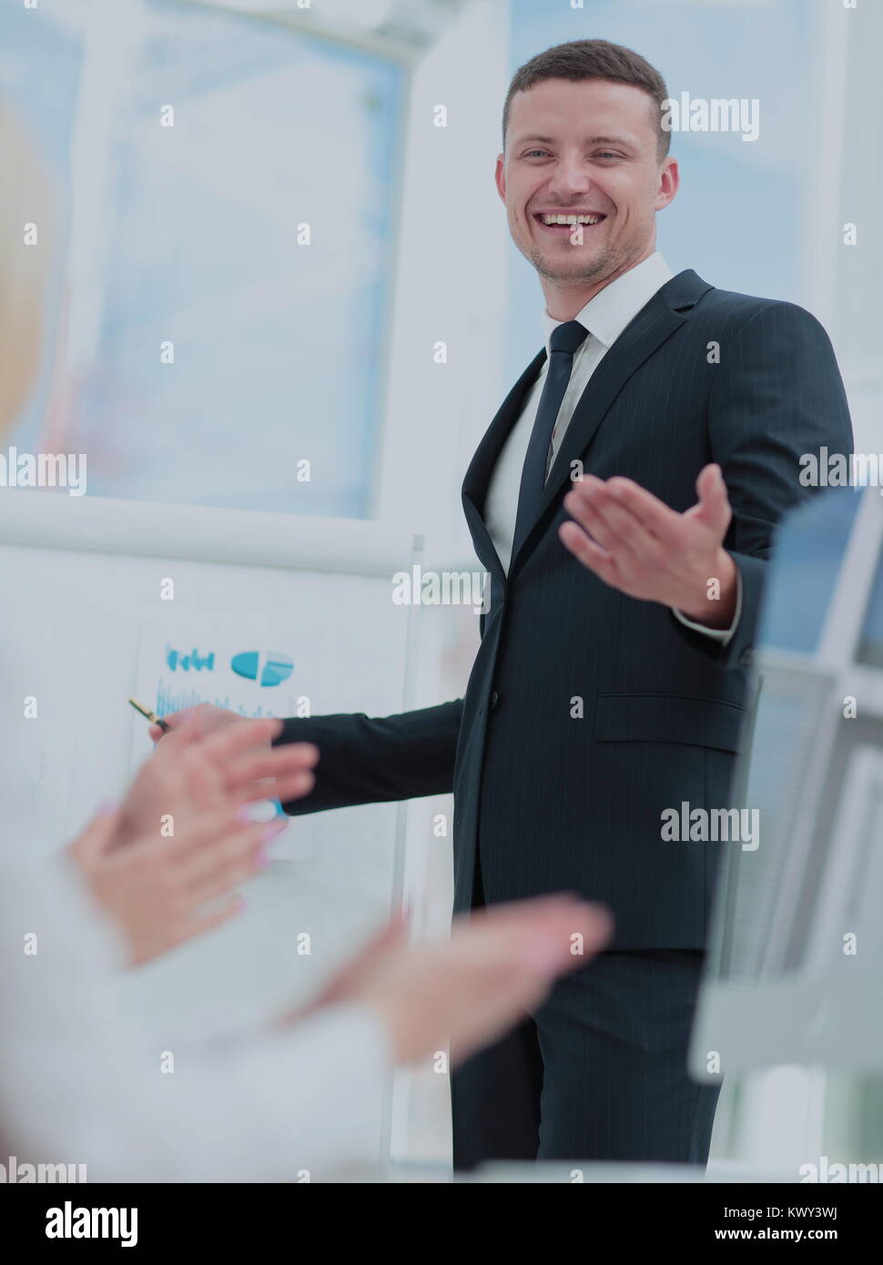 Attractive man making a business presentation to a group Stock Photo ...