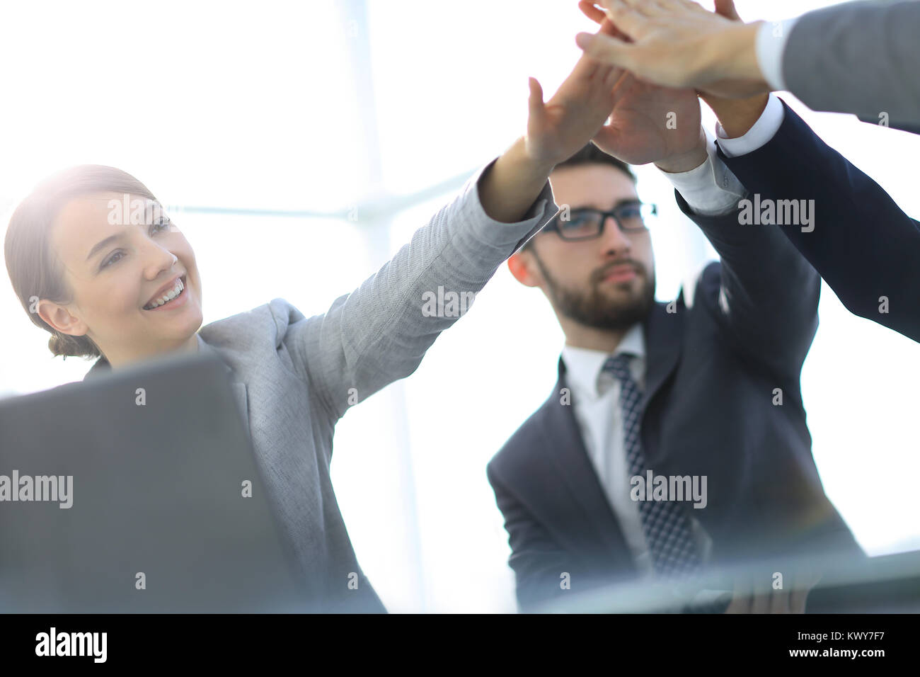 success and winning concept - happy business team giving high five in ...