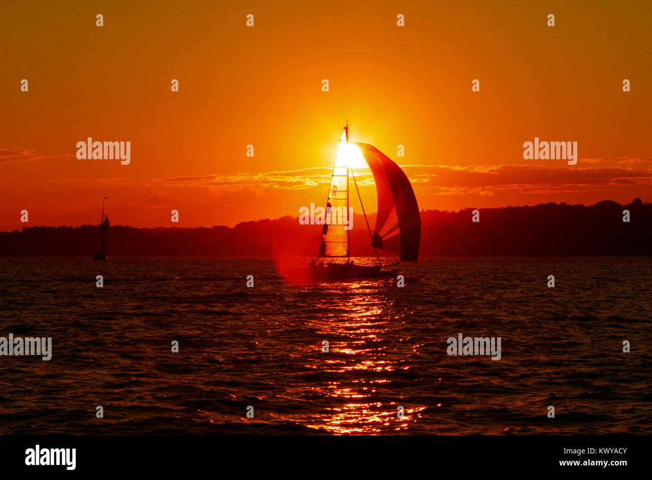 Sail boat at sunset on the ocean Stock Photo - Alamy