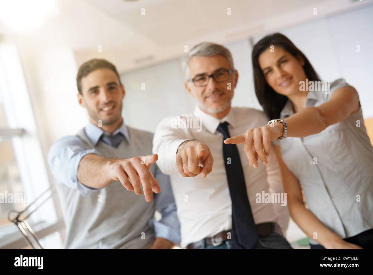 Start-up people pointing at camera Stock Photo - Alamy