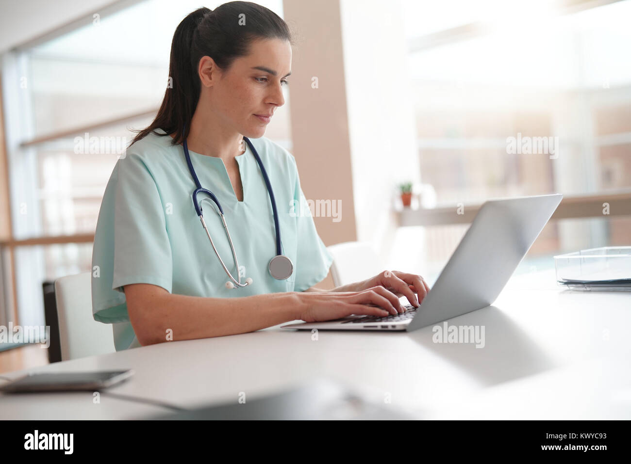 Nurse working on laptop computer Stock Photo - Alamy