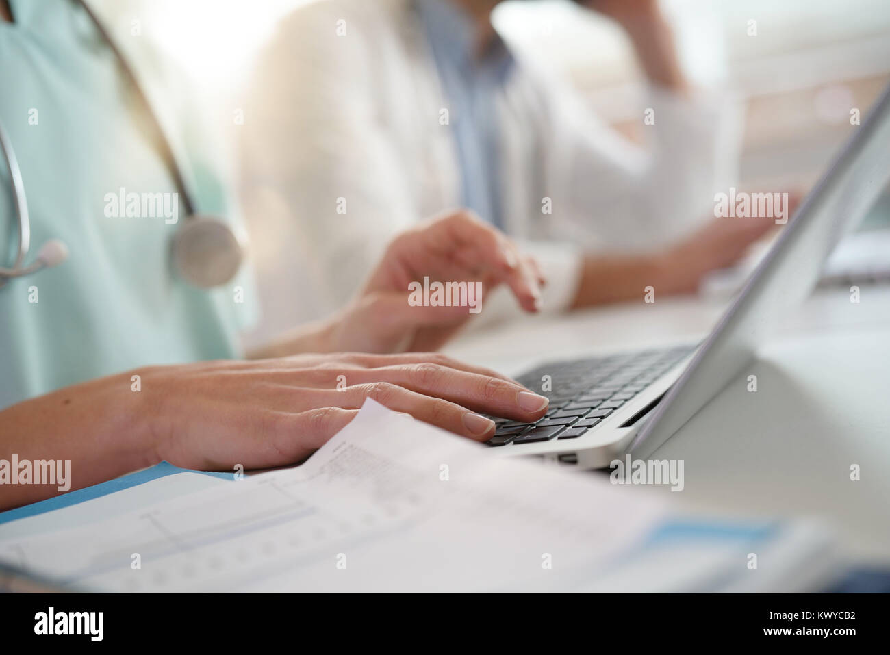 Closeup of nurse's hands typing on laptop keyboard Stock Photo - Alamy