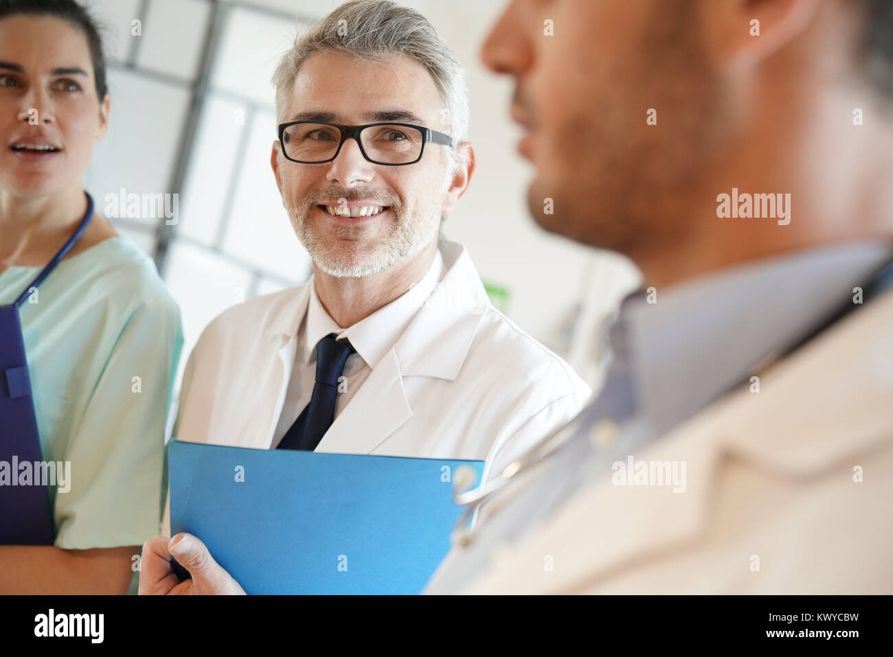 Medical people walking in hospital corridor Stock Photo - Alamy