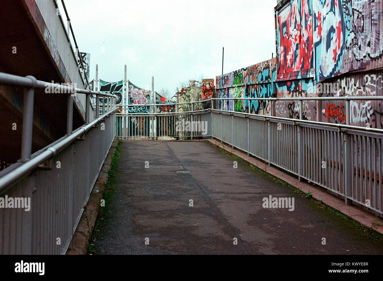 Graffiti on walls next to ramp up pedestrian bridge in Hackney Wick ...