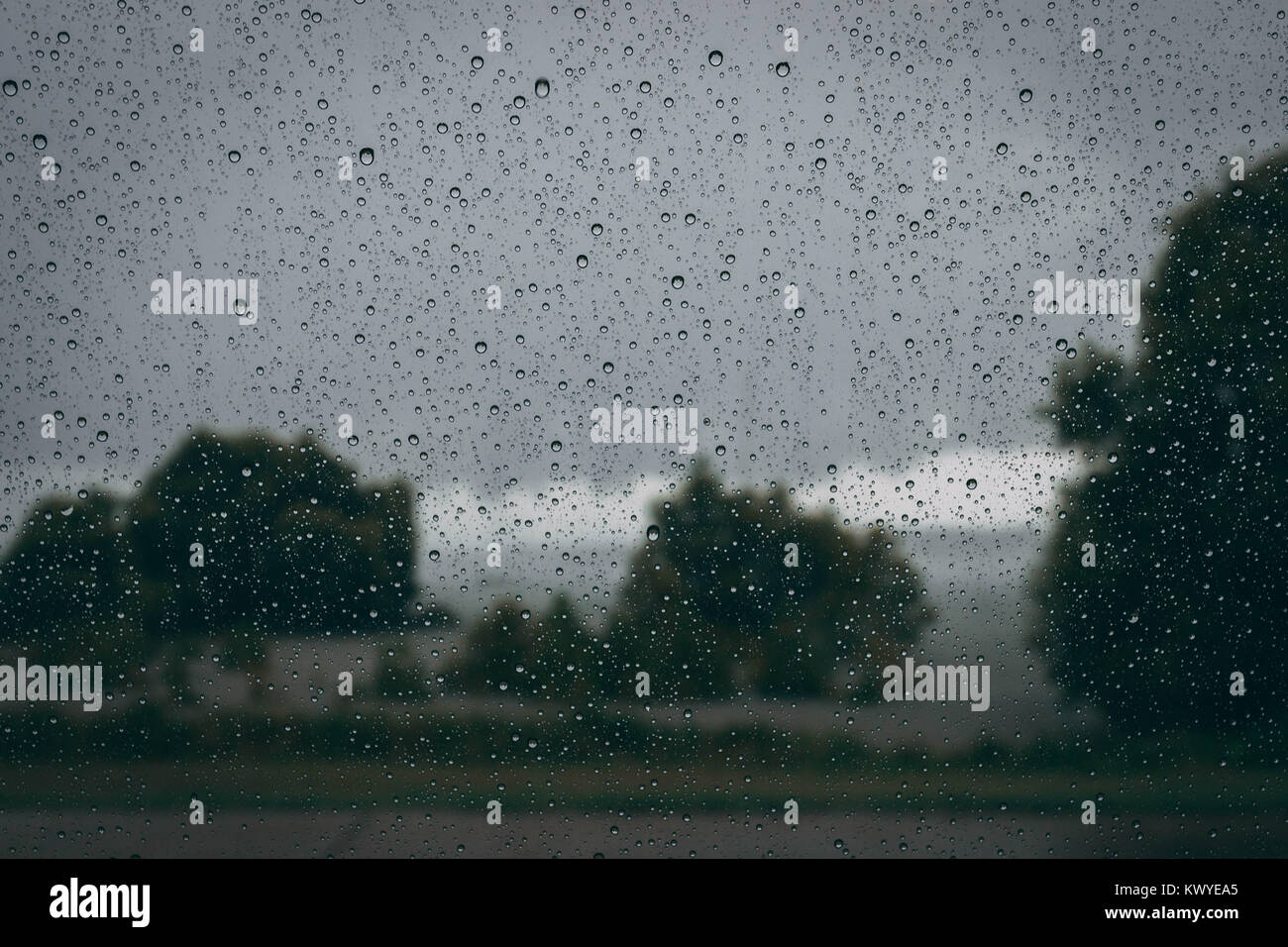Raindrops on a window with overcast ocean behind Stock Photo - Alamy