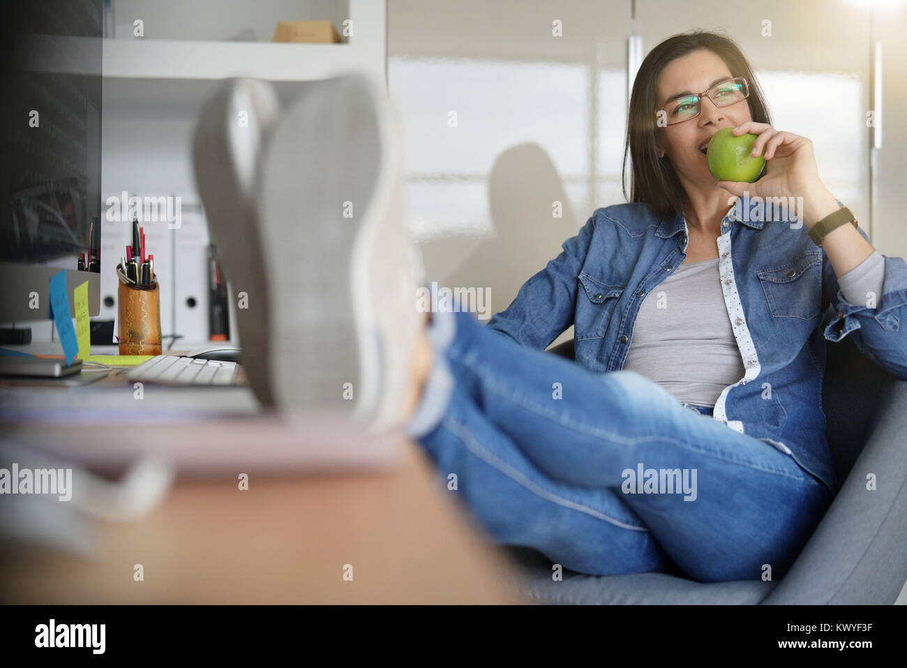 Office worker taking a break in front of desktop Stock Photo - Alamy
