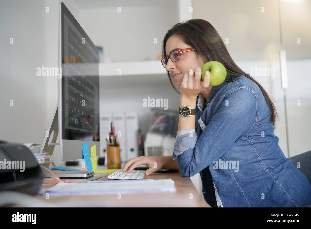 Office worker taking a break in front of desktop Stock Photo - Alamy