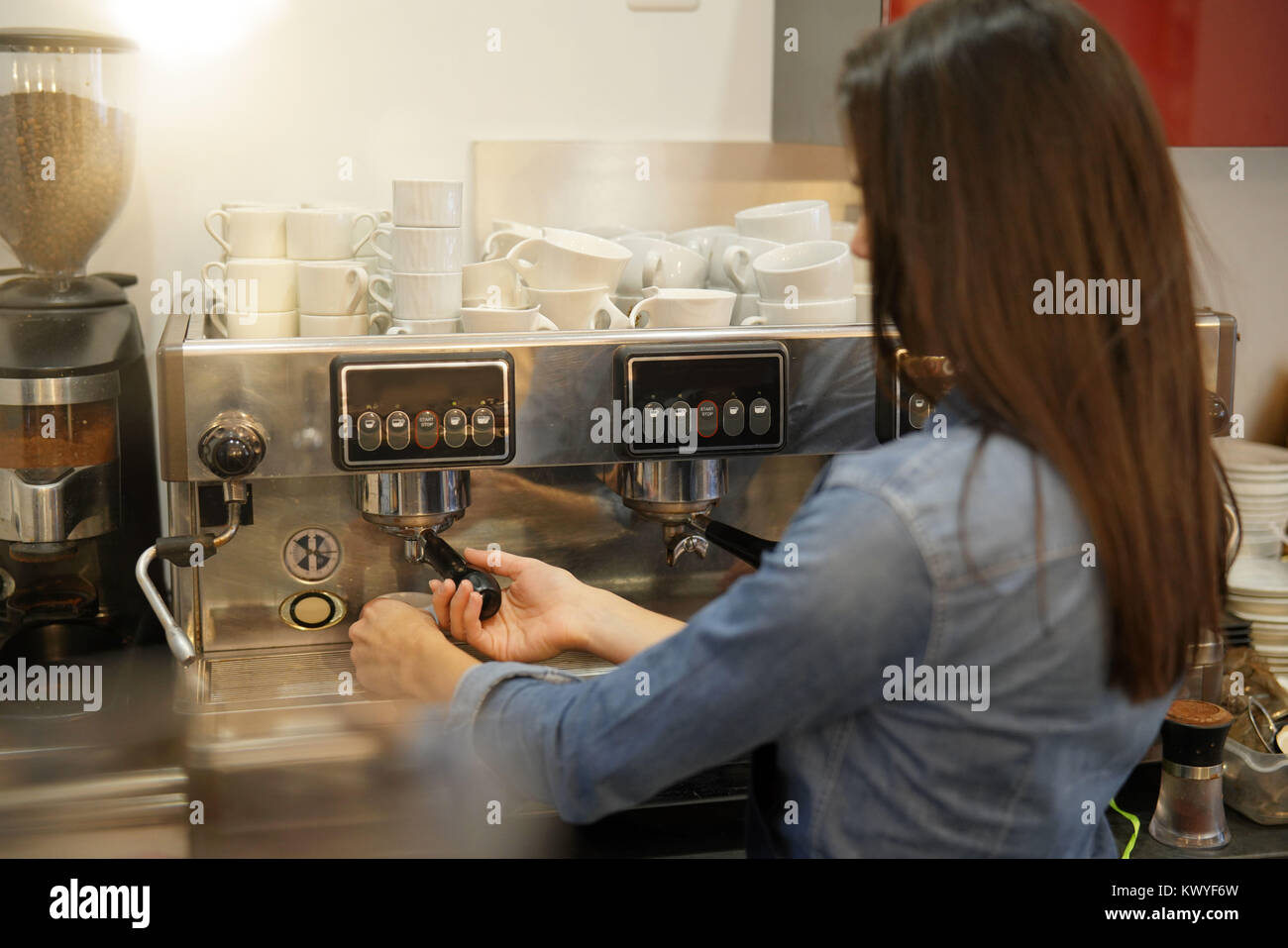 Waitress serving expresso from coffee machine Stock Photo - Alamy