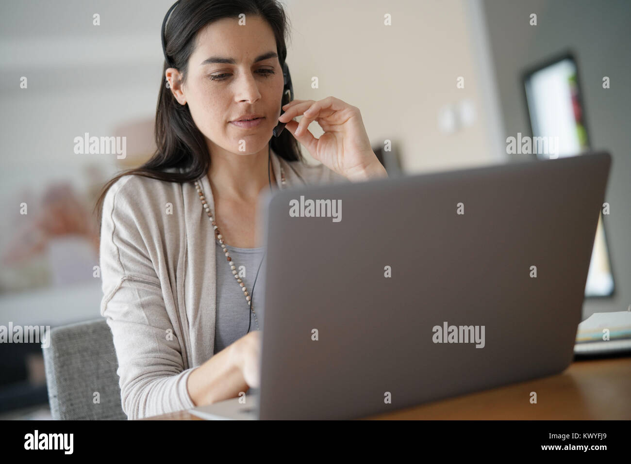 Home-office teleoperator talking on phone with headset Stock Photo - Alamy