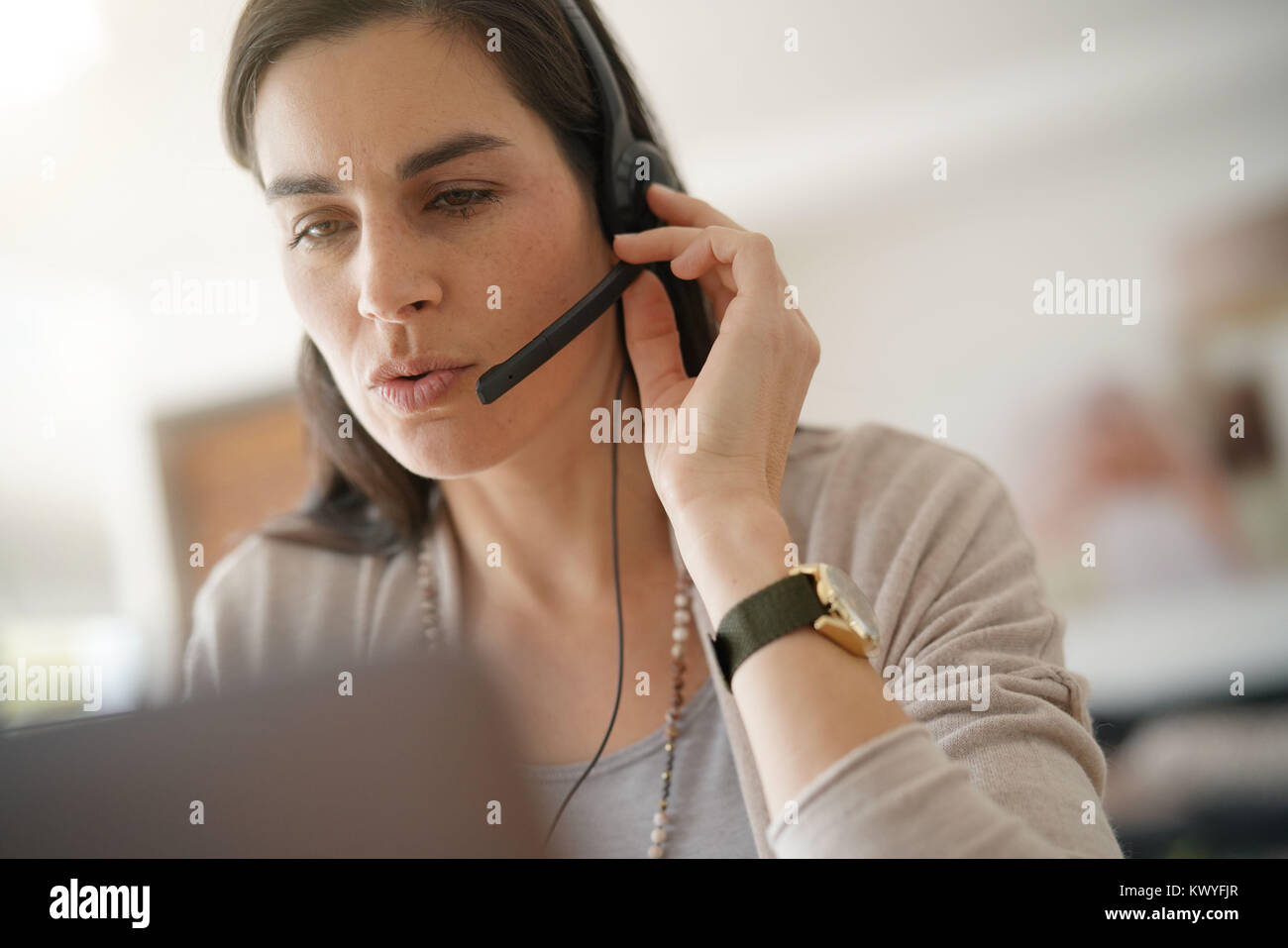 Home-office teleoperator talking on phone with headset Stock Photo - Alamy