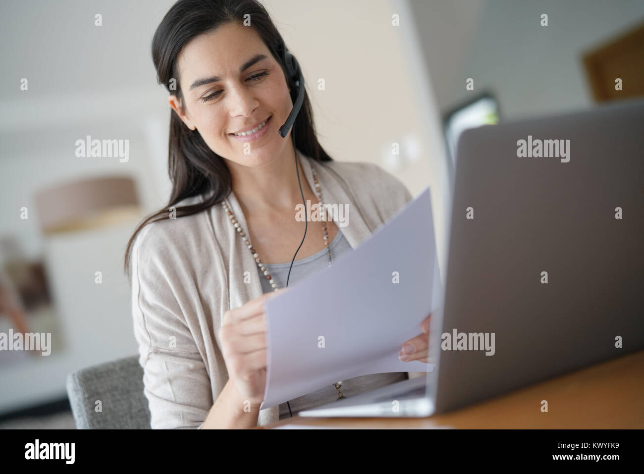 Home-office teleoperator talking on phone with headset Stock Photo - Alamy