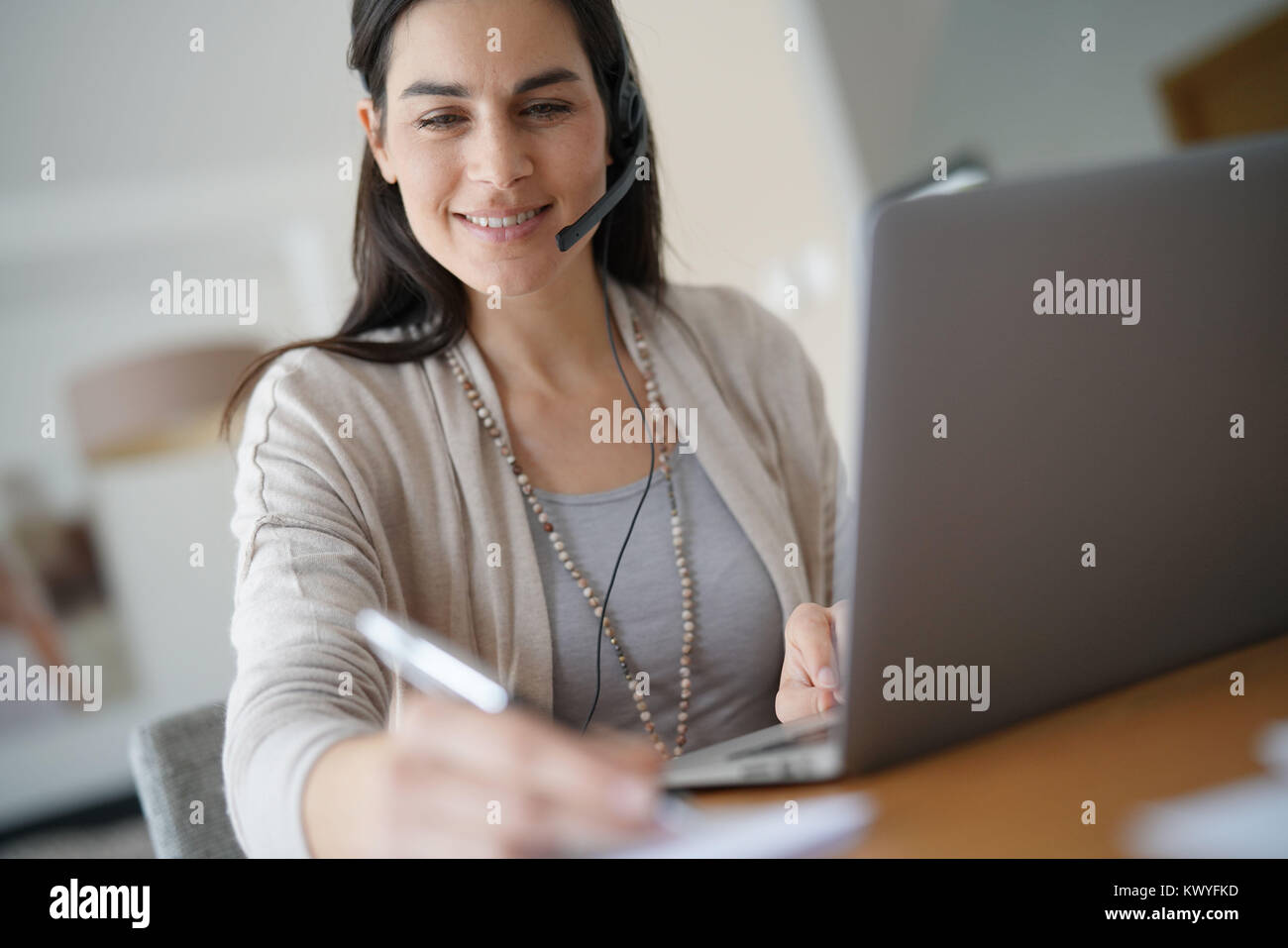 Home-office teleoperator talking on phone with headset Stock Photo - Alamy