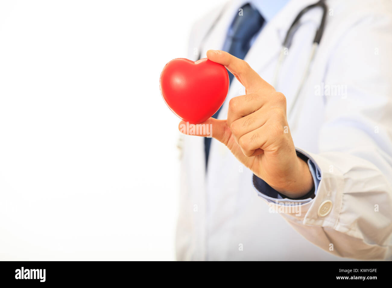 Doctor holding a heart standing on white background Stock Photo - Alamy