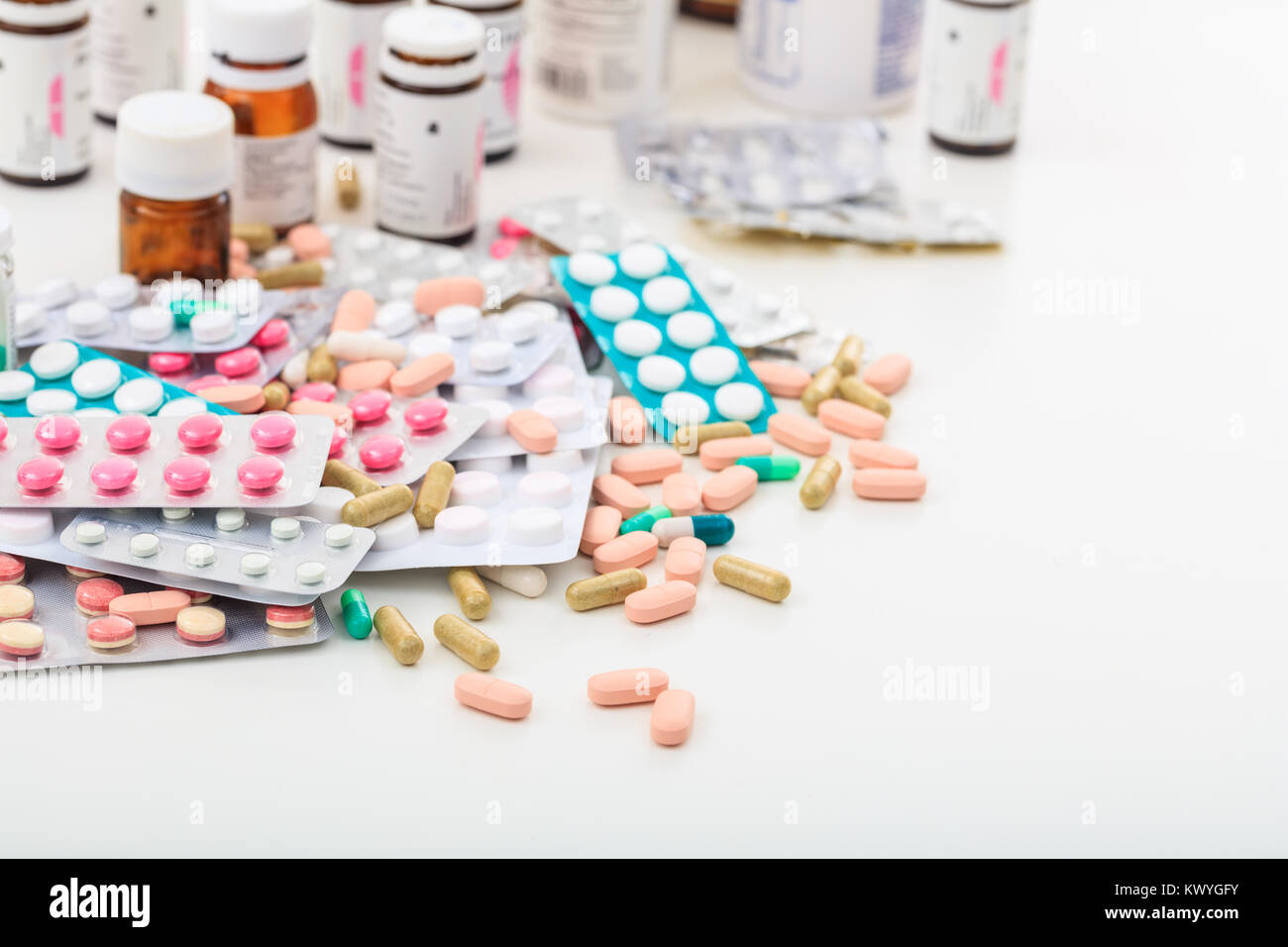 Stack of colorful pills and containers on white background Stock Photo ...