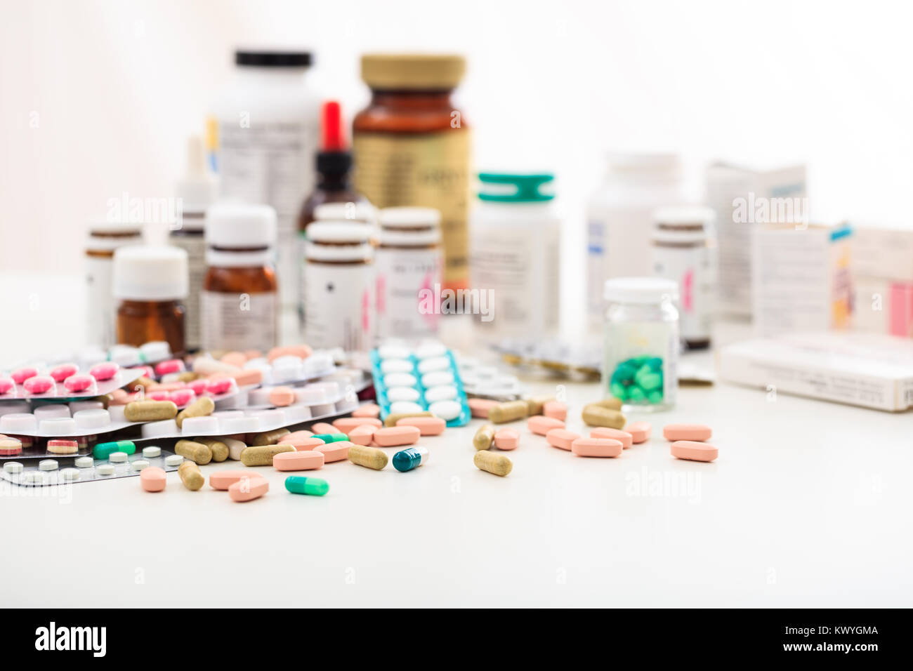 Stack of colorful pills and containers on white background Stock Photo ...