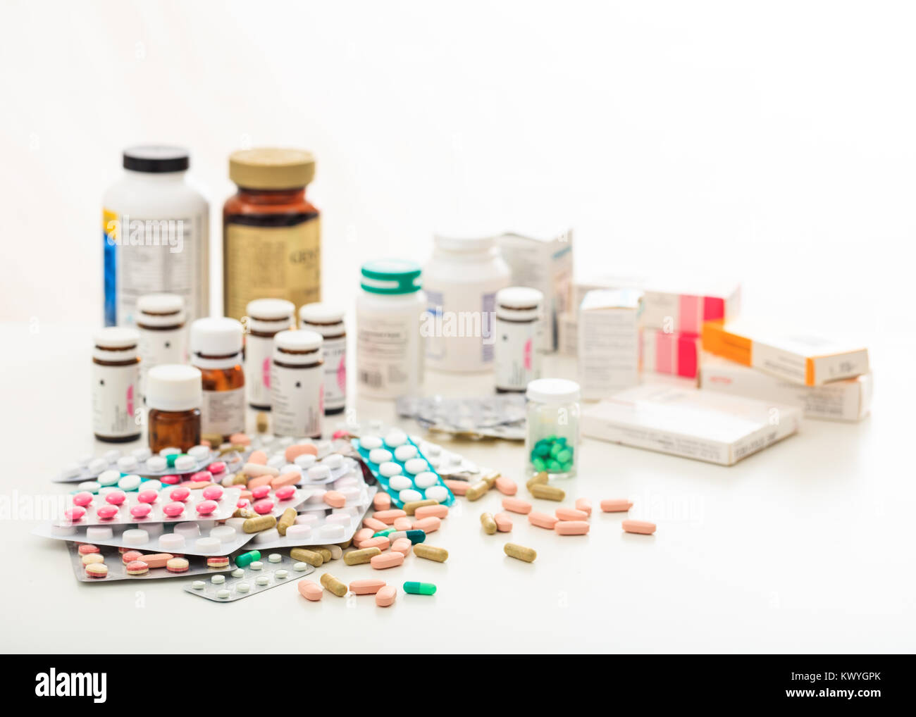 Stack of colorful pills and containers on white background Stock Photo ...