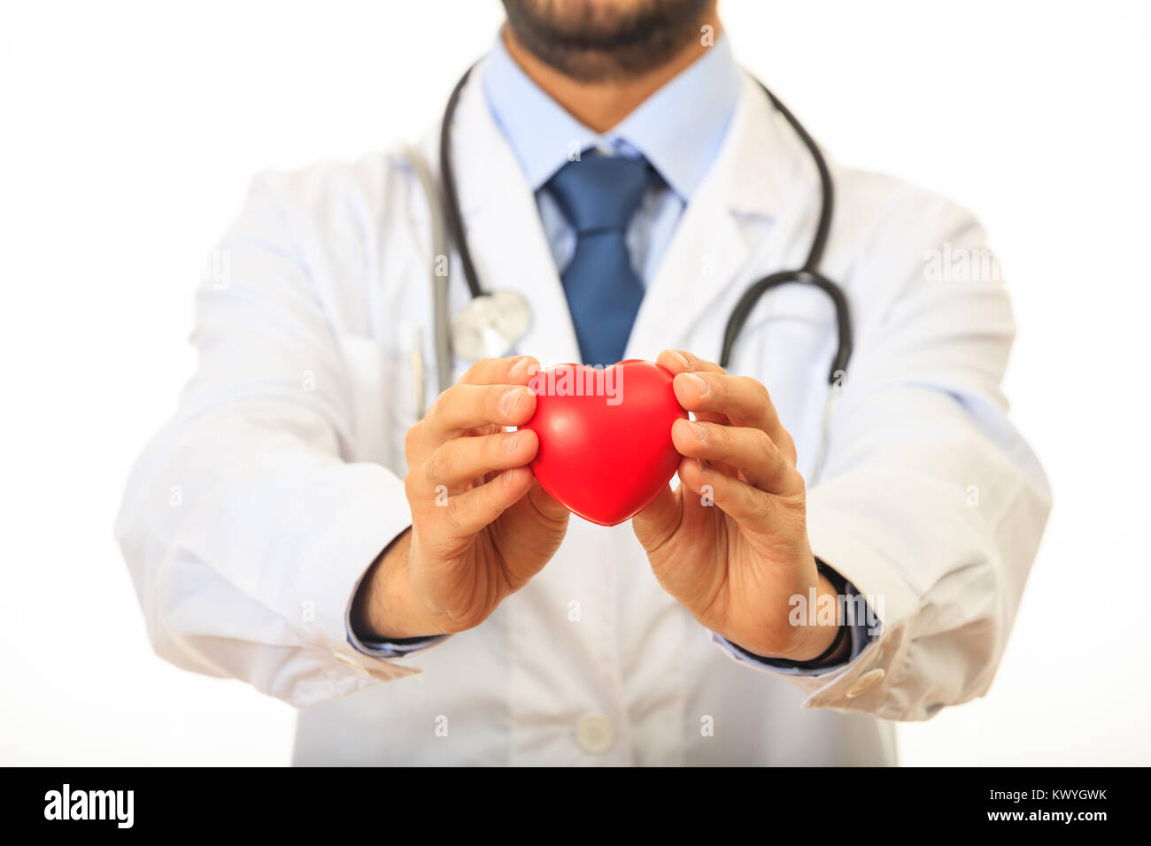 Doctor holding a heart standing on white background Stock Photo - Alamy