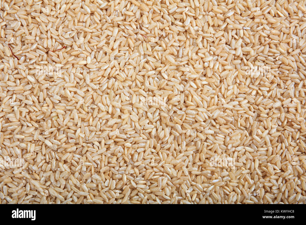 Brown unrefined rice as background Stock Photo - Alamy