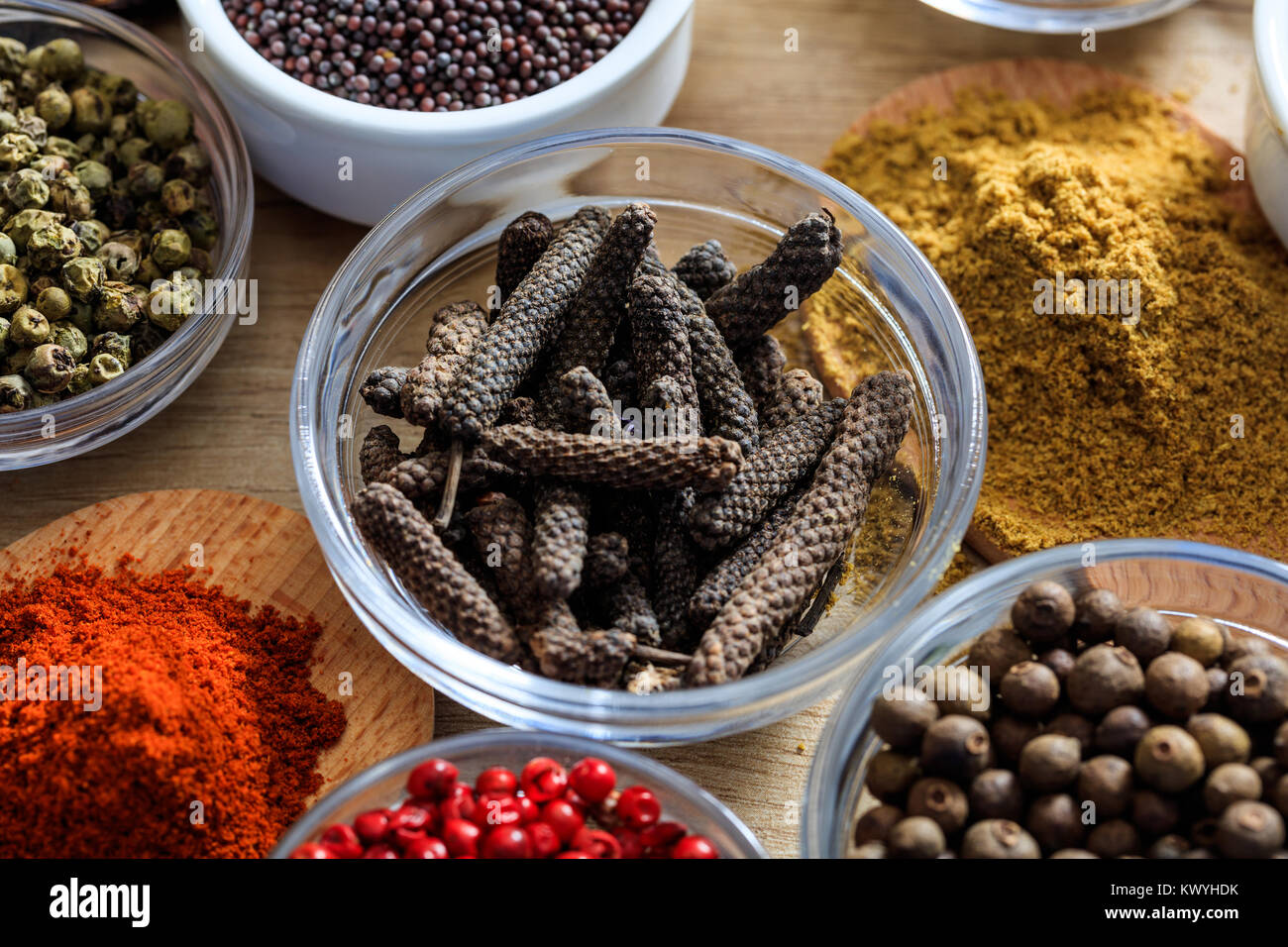 Long pepper and other spices on a wooden surface Stock Photo - Alamy